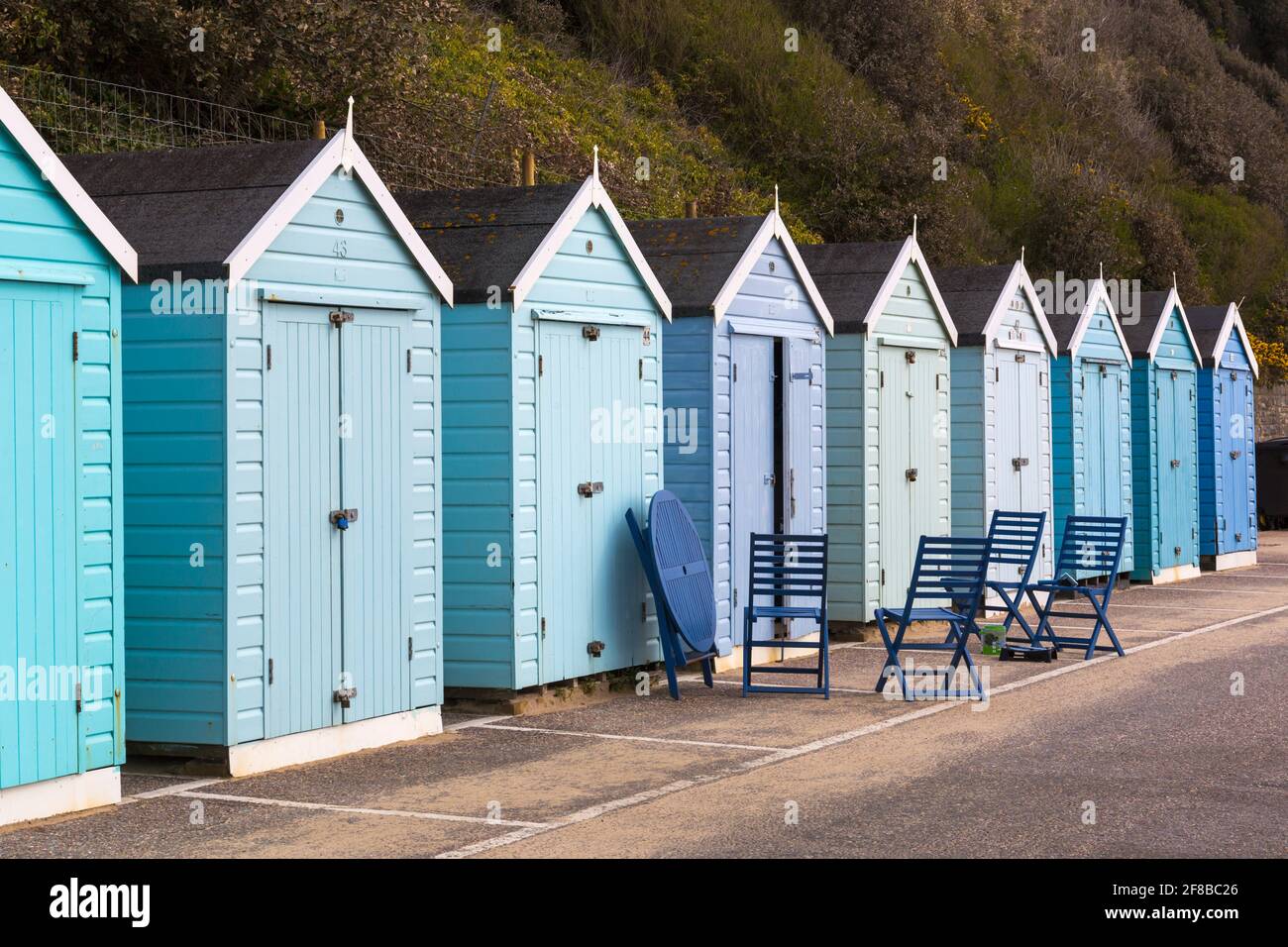 Paint it blue - row of various shades of blue beach huts with blue ...