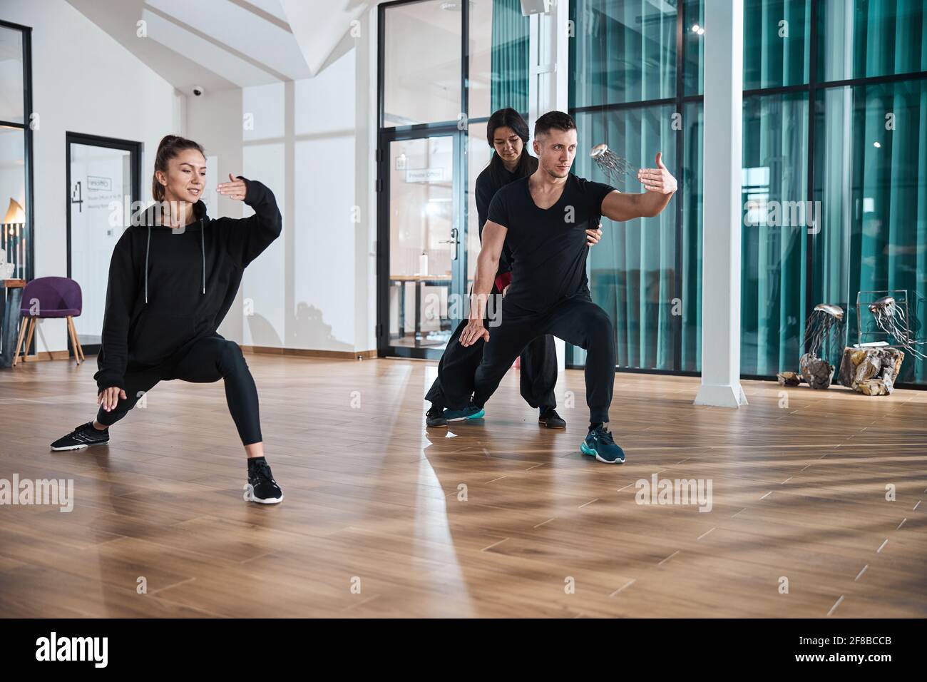 Teacher correcting the stance of male student Stock Photo - Alamy