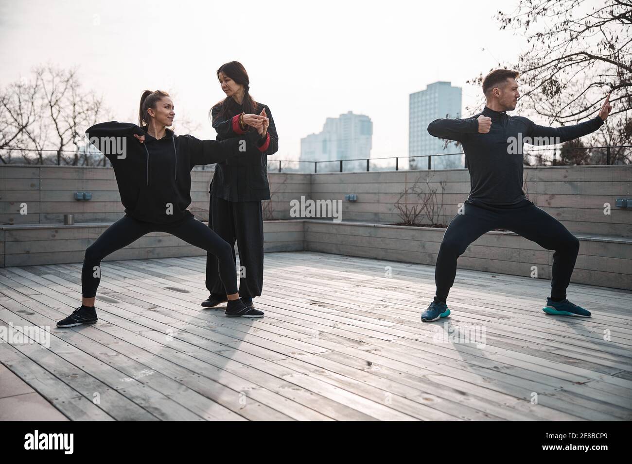 Wushu instructor changing finger position of woman Stock Photo - Alamy