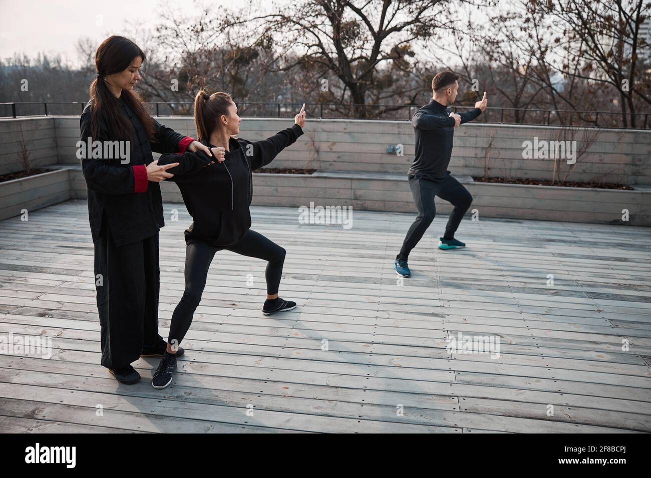 Watchful kung fu teacher making corrections to student pose Stock Photo ...
