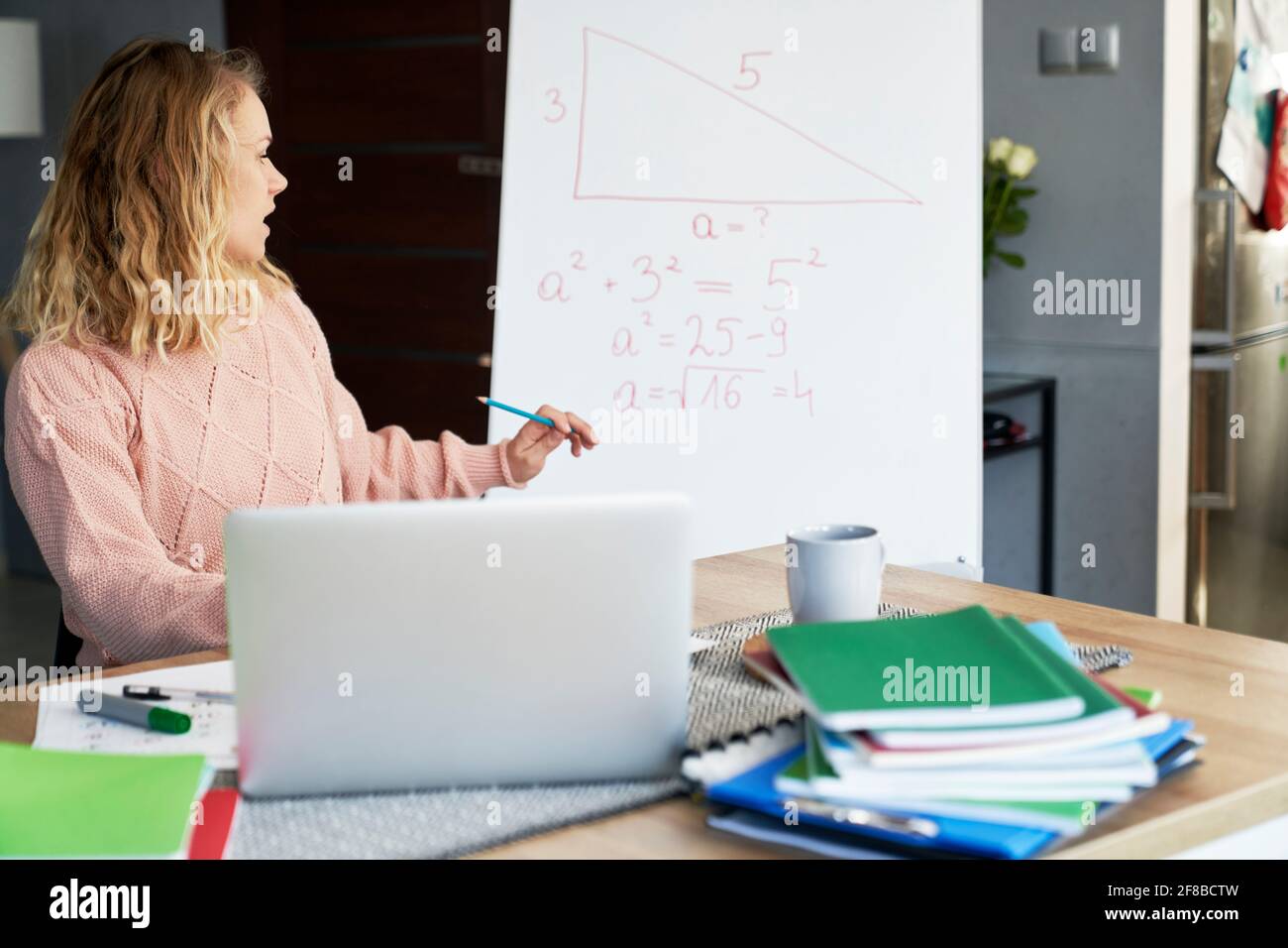 Teacher woman teaching remotely from home Maths class Stock Photo - Alamy