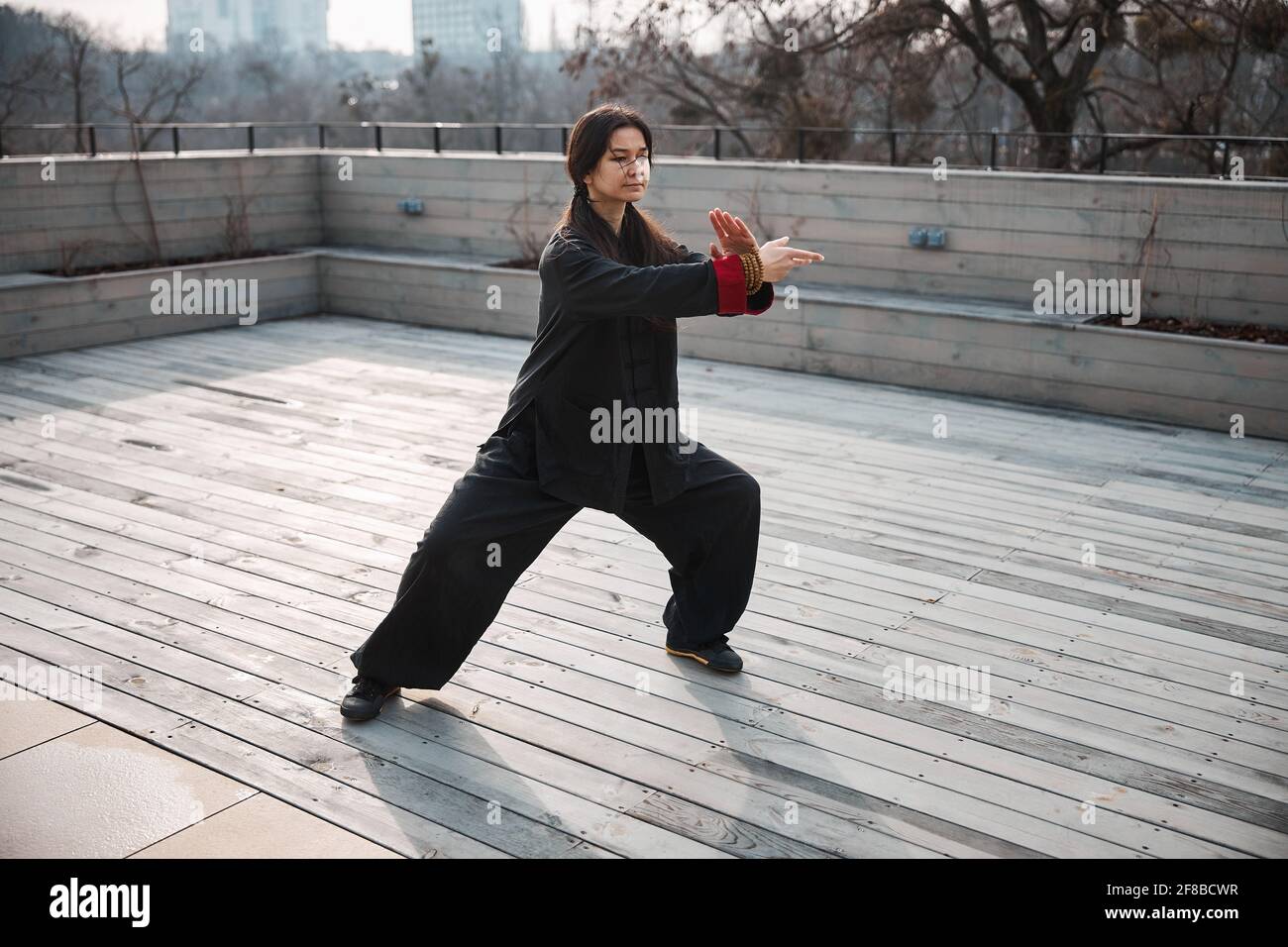 Cross hand stance of a woman doing tai chi Stock Photo - Alamy