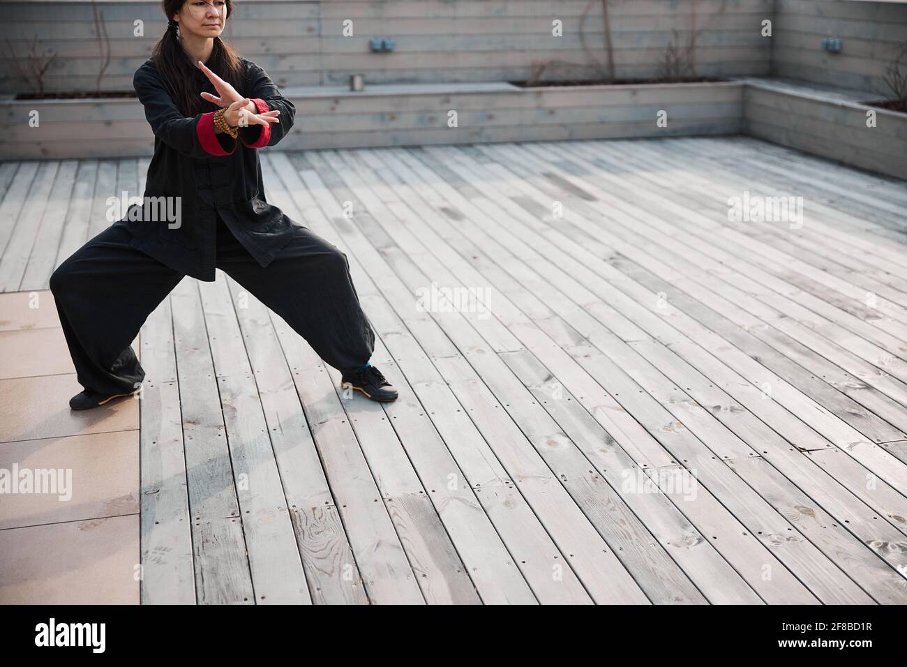Qigong form moving left hand over right Stock Photo - Alamy