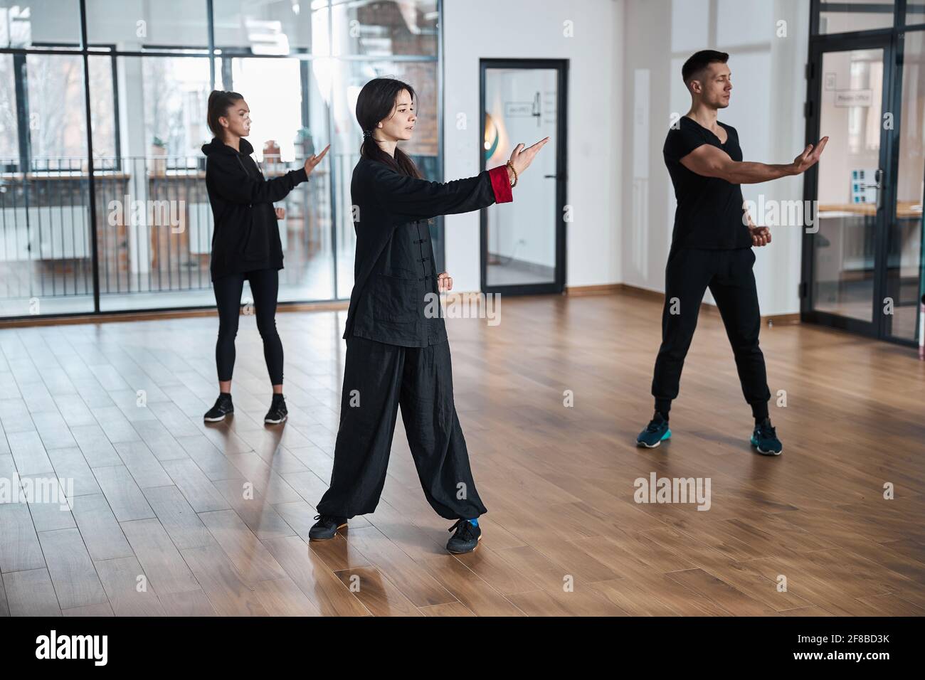 Wushu teacher showing students a hand movement Stock Photo - Alamy