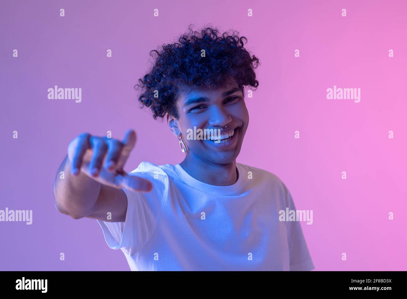 Handsome smiling guy gesturing hi-res stock photography and images - Alamy