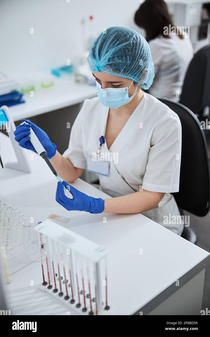 Lab technician assembling a laboratory tool for a blood test Stock ...