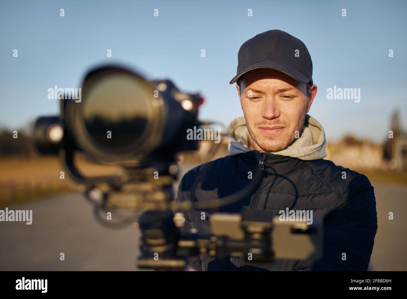 Content creator during filming with camera and gimbal. Portrait of ...