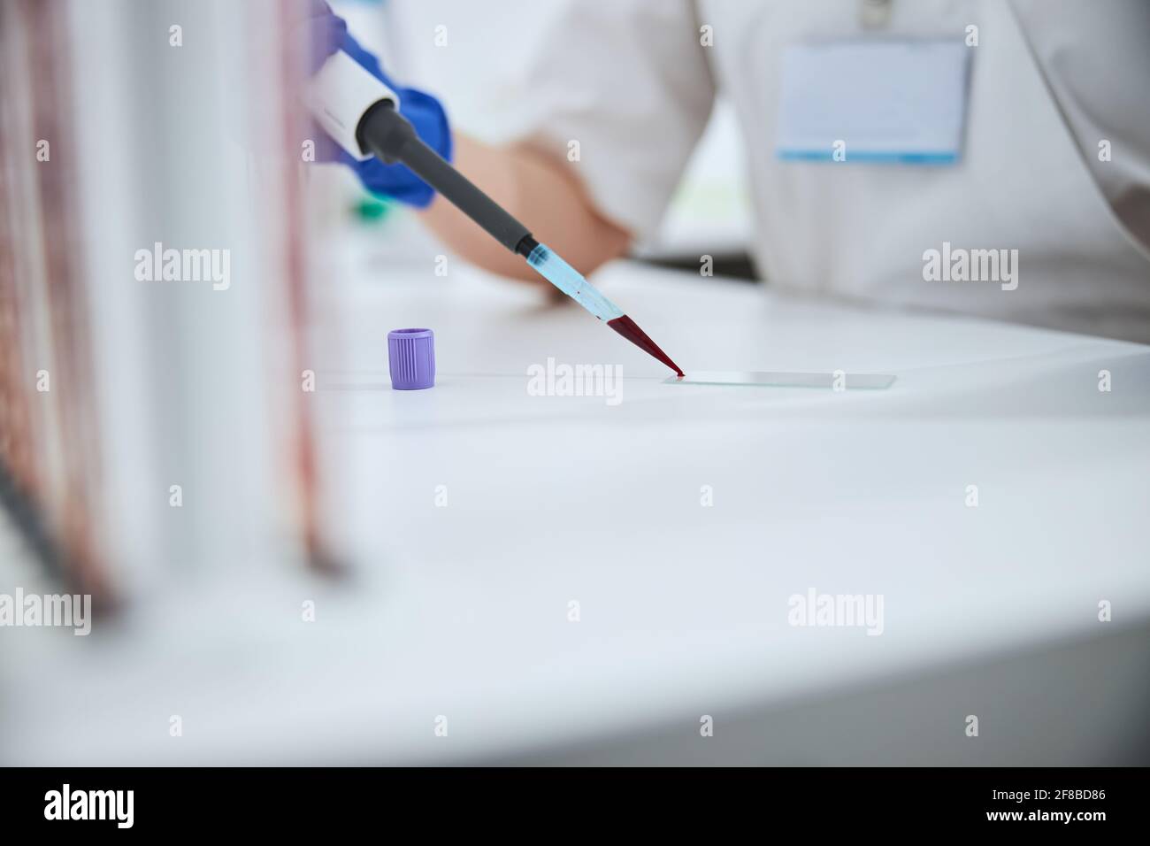 Scientist preparing a specimen for microscopic examination Stock Photo ...