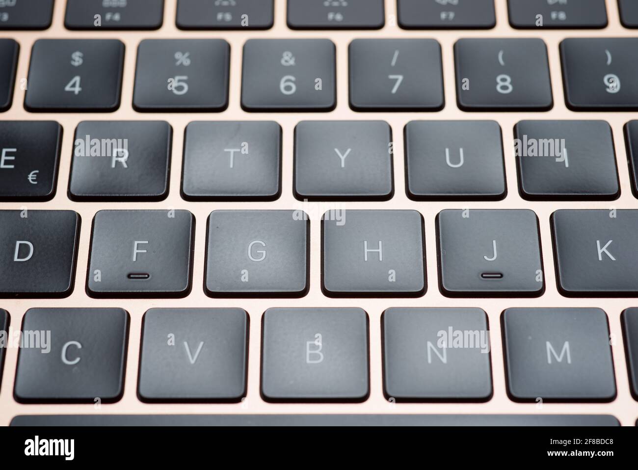 Forefront of a pink laptop keyboard Stock Photo - Alamy