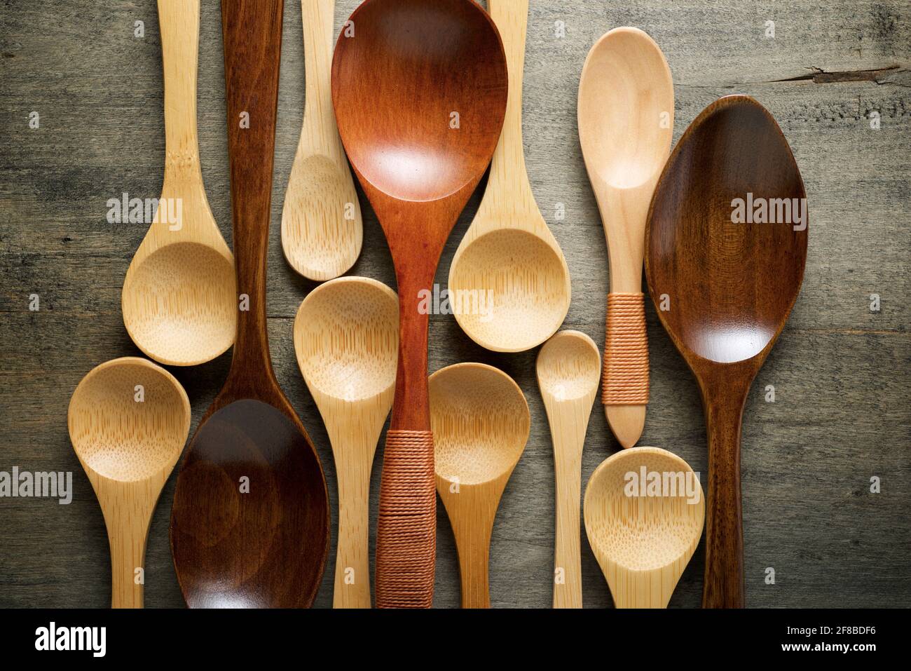 Collection of spoons on a wood table Stock Photo - Alamy