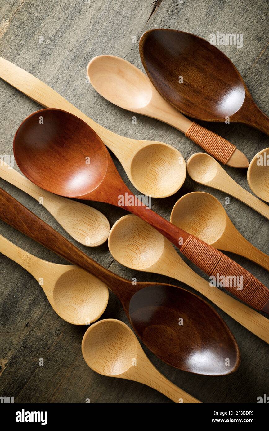 Collection of spoons on a wood table Stock Photo - Alamy