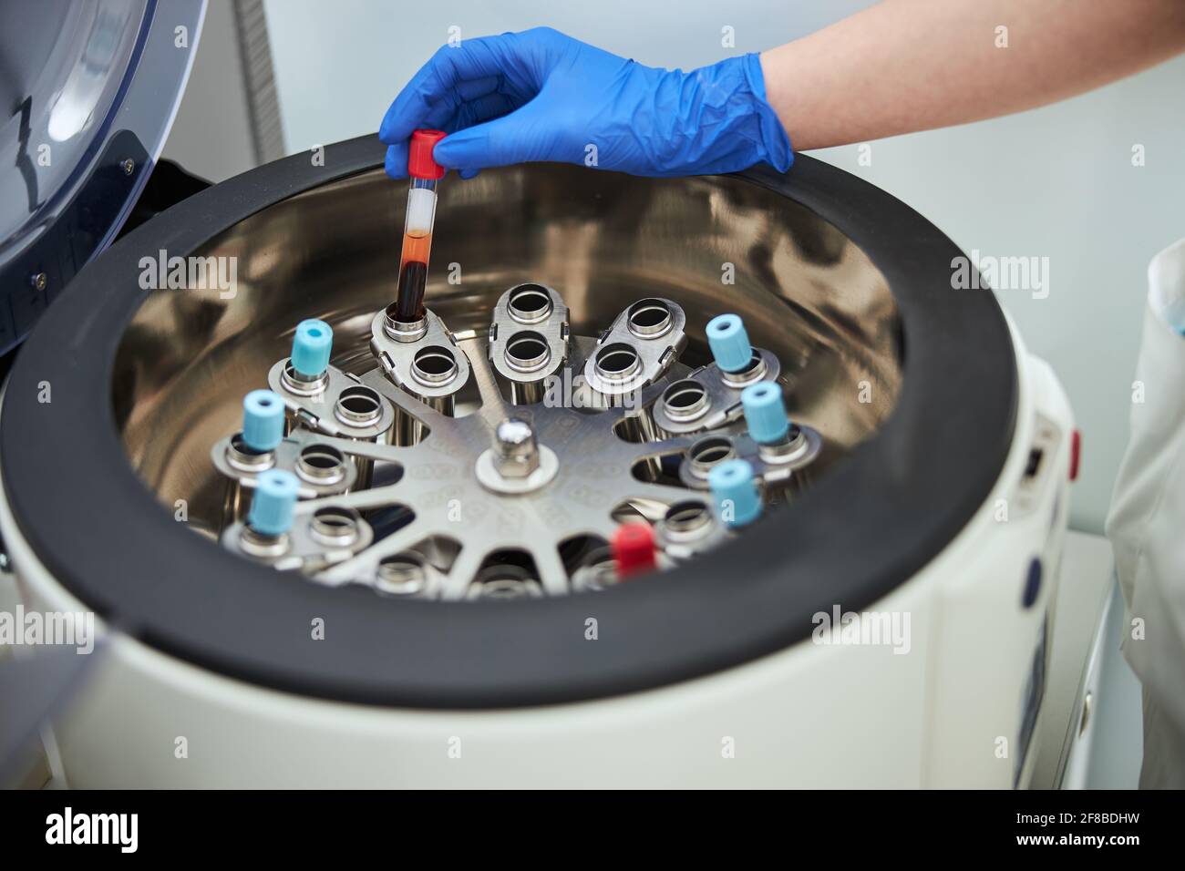 Biochemist using a centrifuge machine for a biochemical test Stock ...