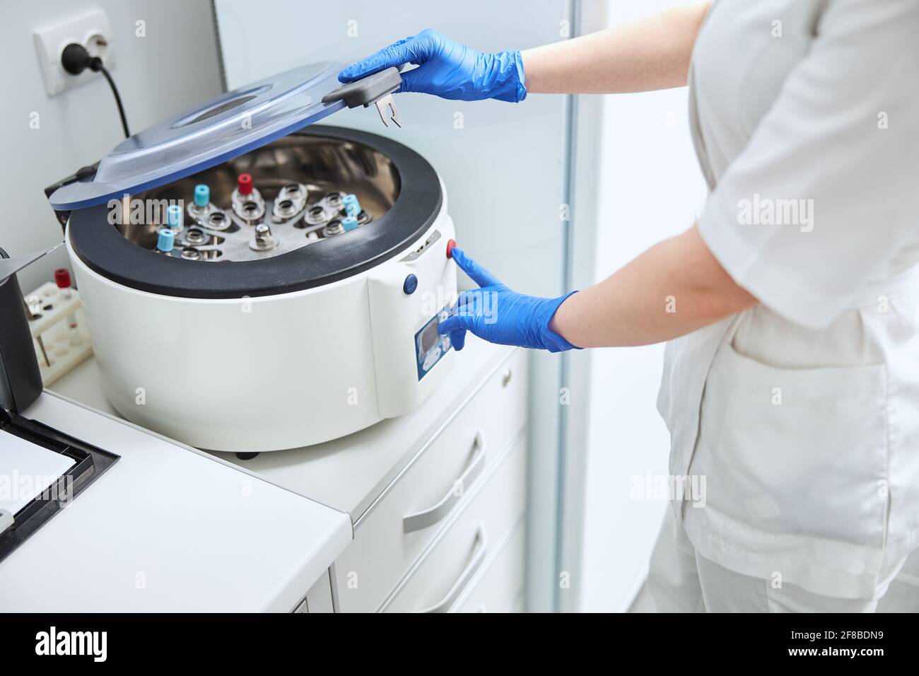 Biochemist preparing the laboratory device for a blood test Stock Photo ...