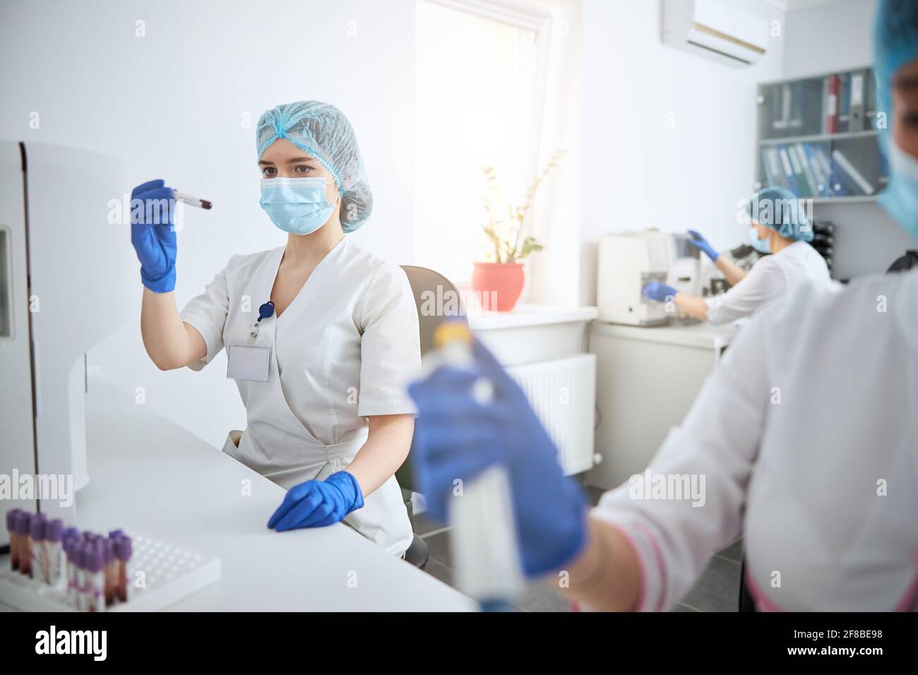 Female biochemist performing a complete blood count Stock Photo - Alamy
