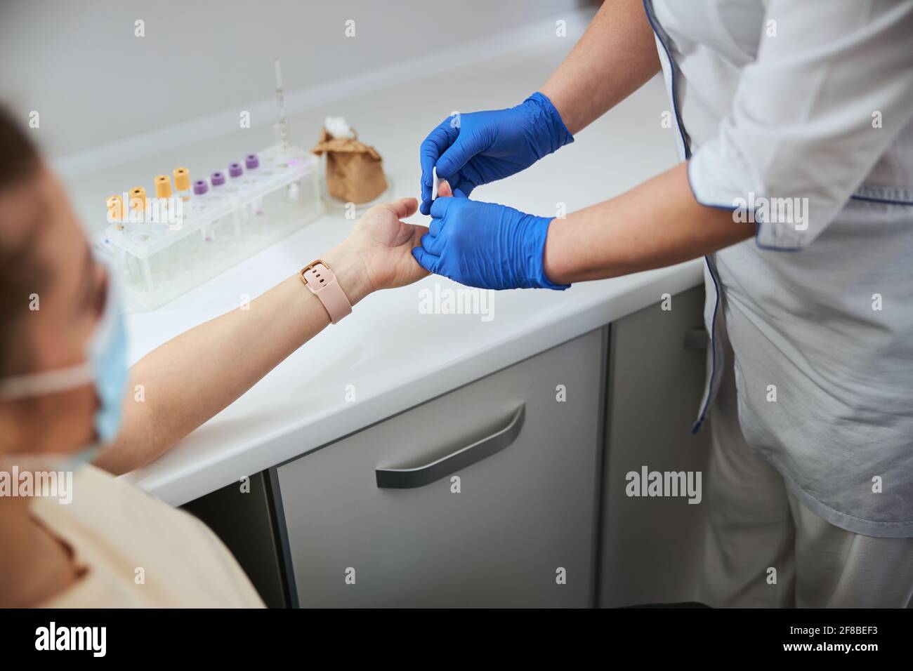 Nurse preparing a female for a finger prick blood test Stock Photo - Alamy