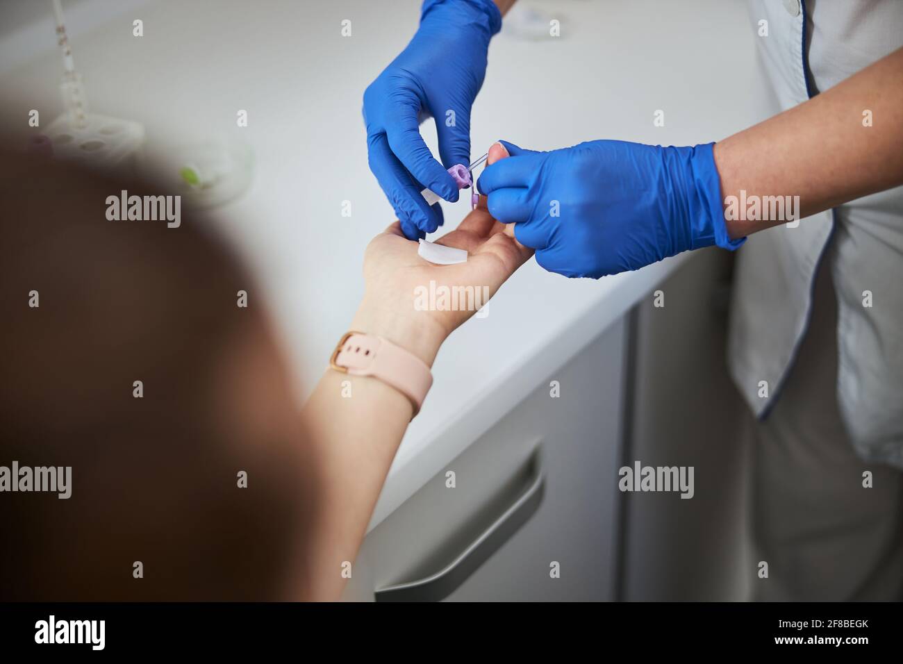 Nurse using a finger prick method for a hematological test Stock Photo ...