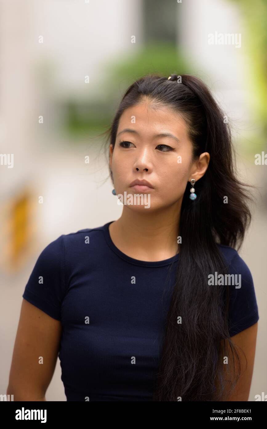 Portrait of beautiful rebel Asian woman thinking outdoors Stock Photo ...