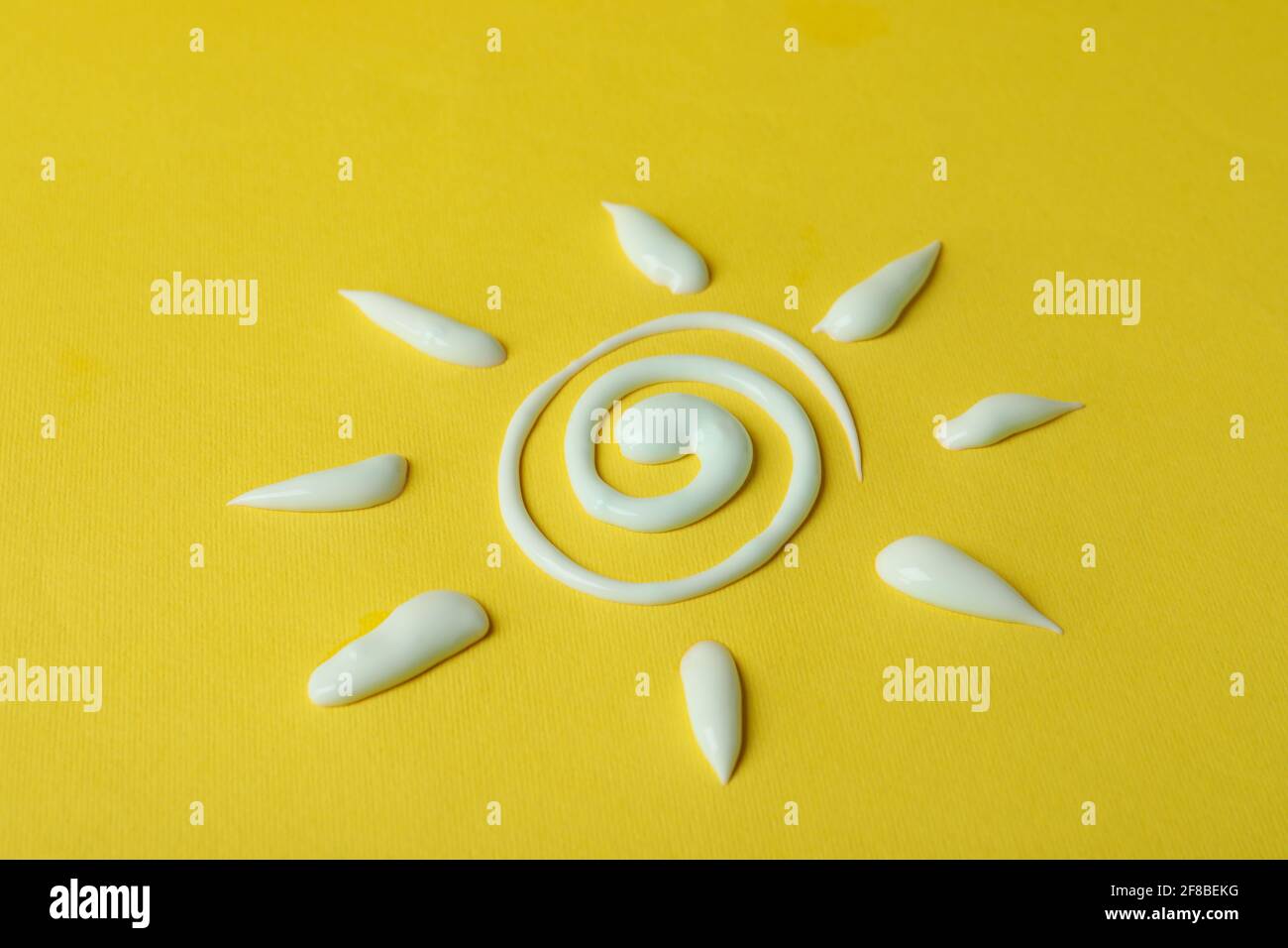 Sun made of sunscreen on yellow background Stock Photo - Alamy