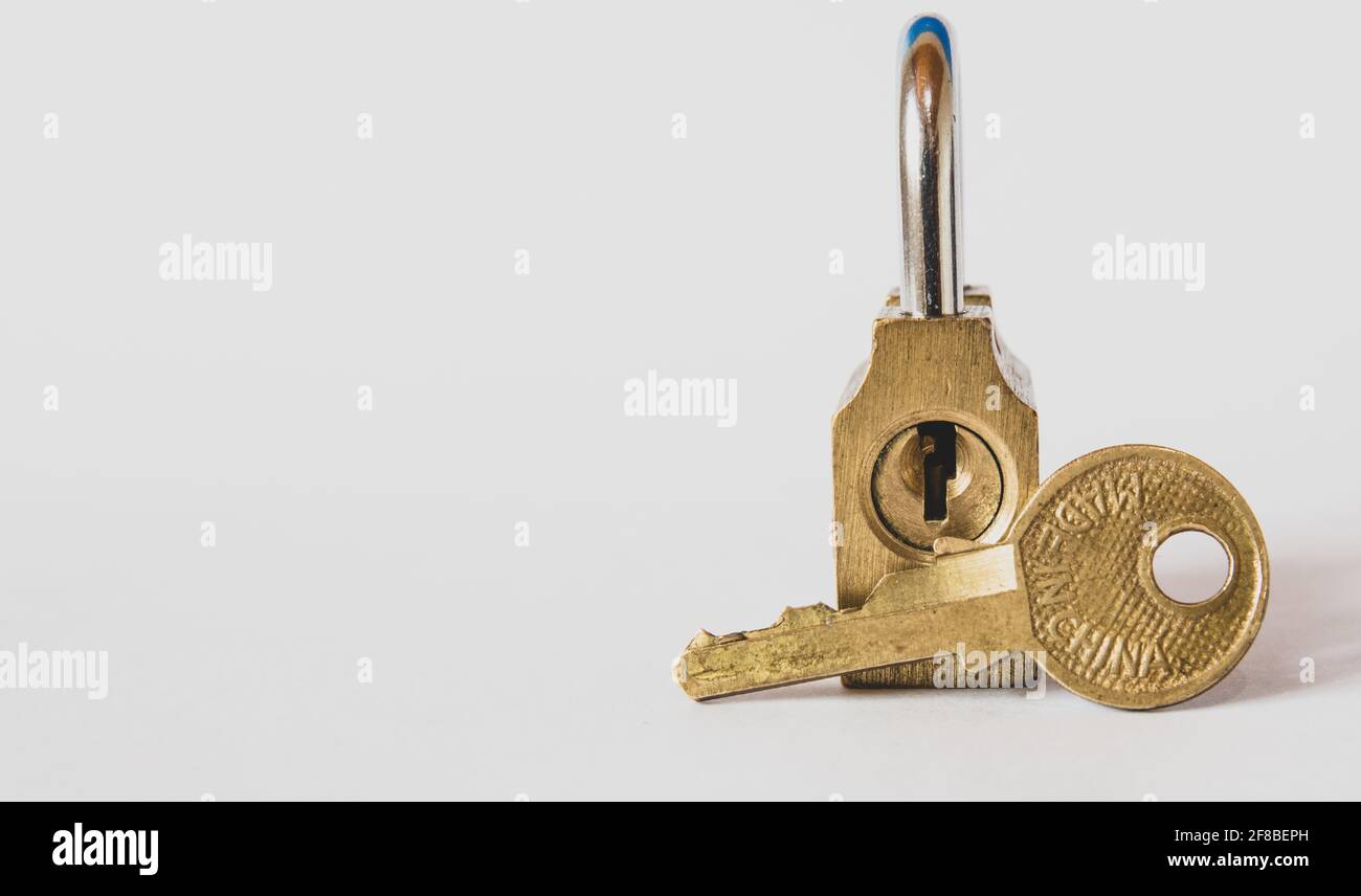 Brass padlock along with its key on a solid white background Stock ...