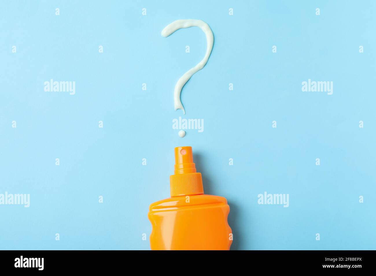 Sunscreen with question mark on blue background Stock Photo - Alamy