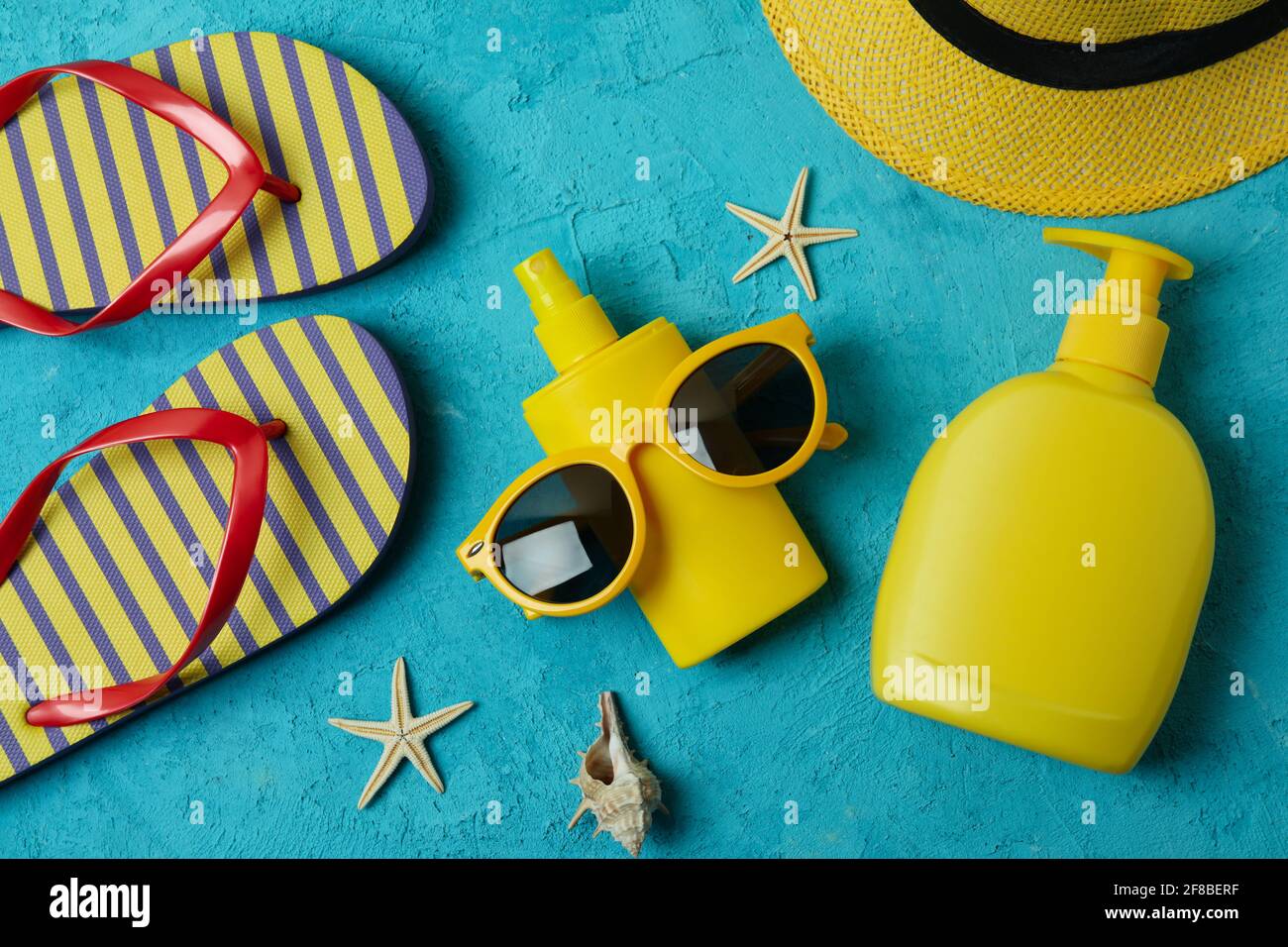 Summer concept with sunscreen on blue textured background Stock Photo ...