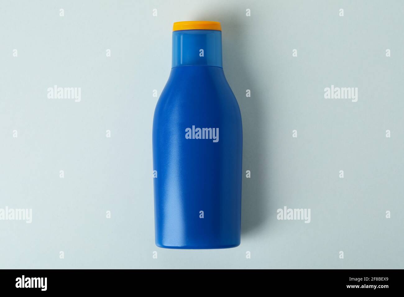 Blank blue bottle of sunscreen on white background Stock Photo - Alamy
