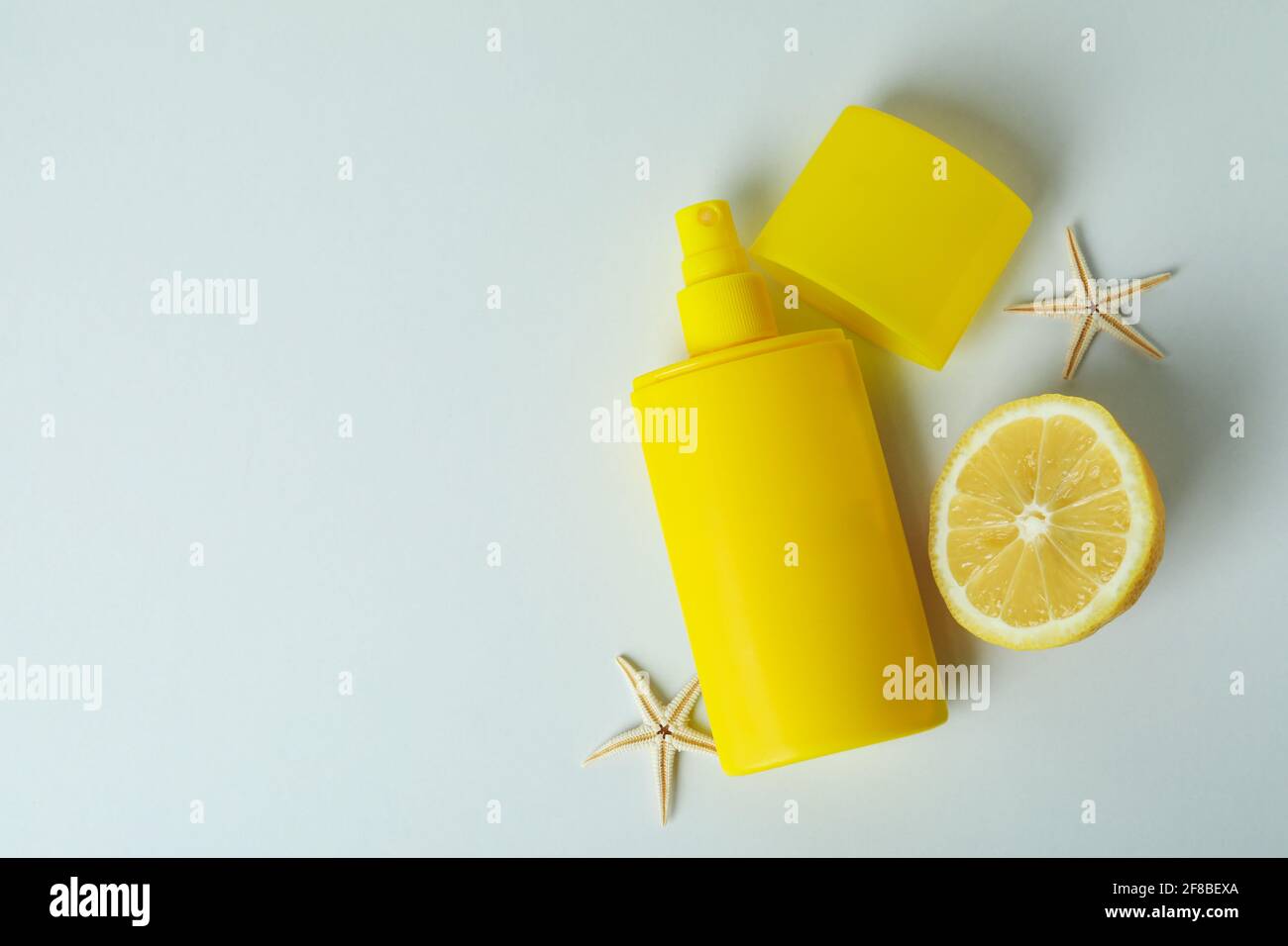 Sunscreen, starfishes and lemon on white background Stock Photo - Alamy