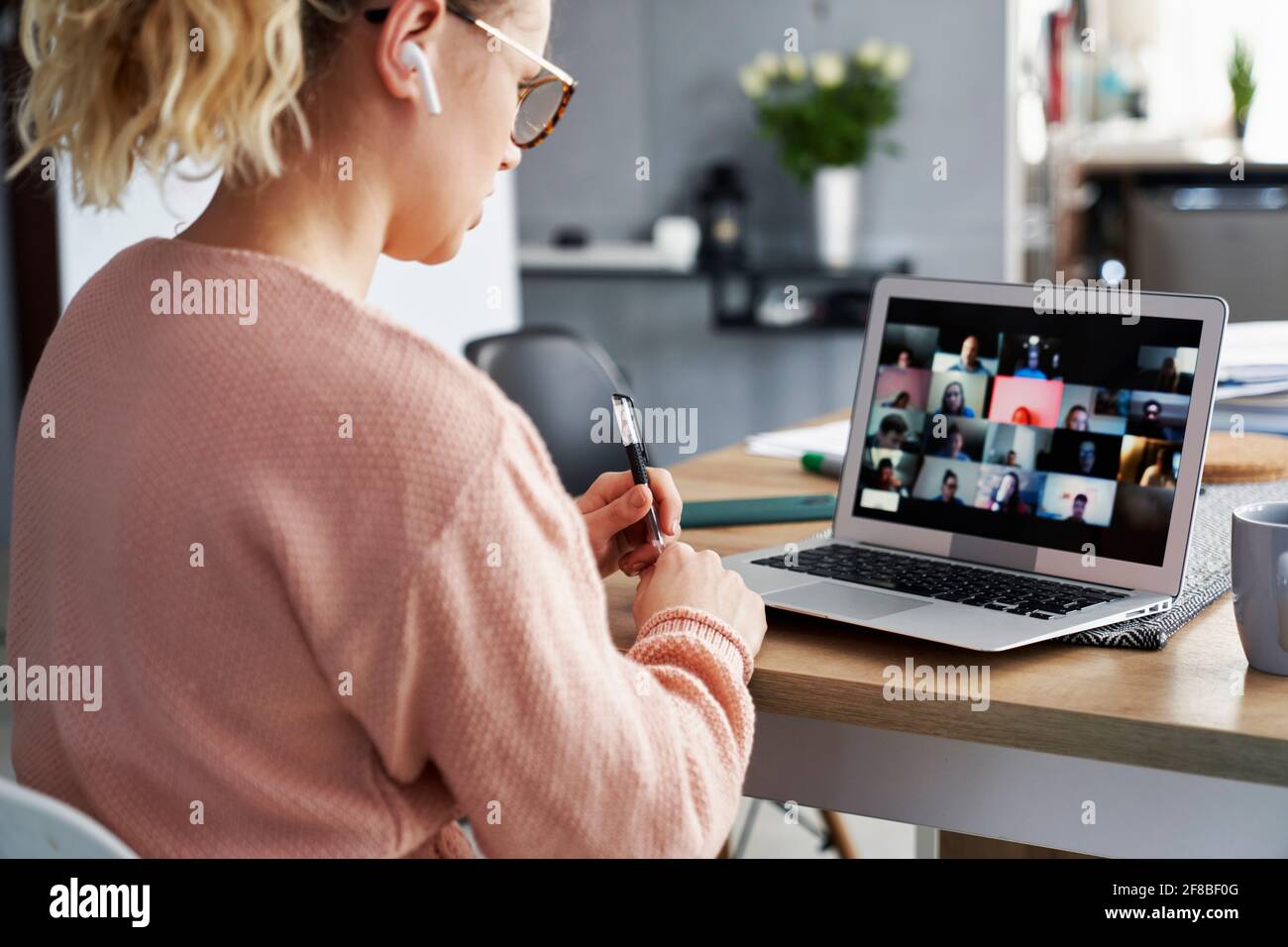 Young teacher teaching video conference e-learning to elementary school ...