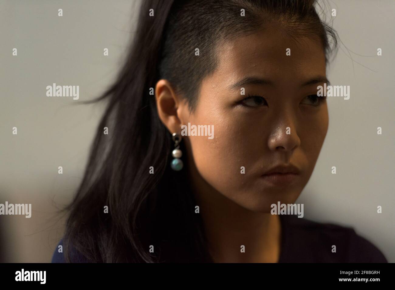 Close-up portrait of beautiful rebel Asian woman face outdoors Stock ...