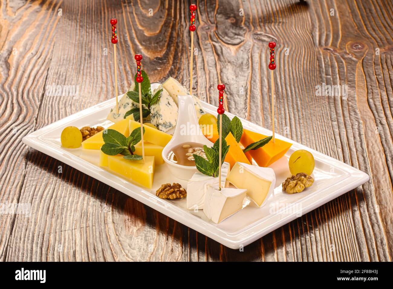 Cheese plate mix with honey and nuts Stock Photo - Alamy