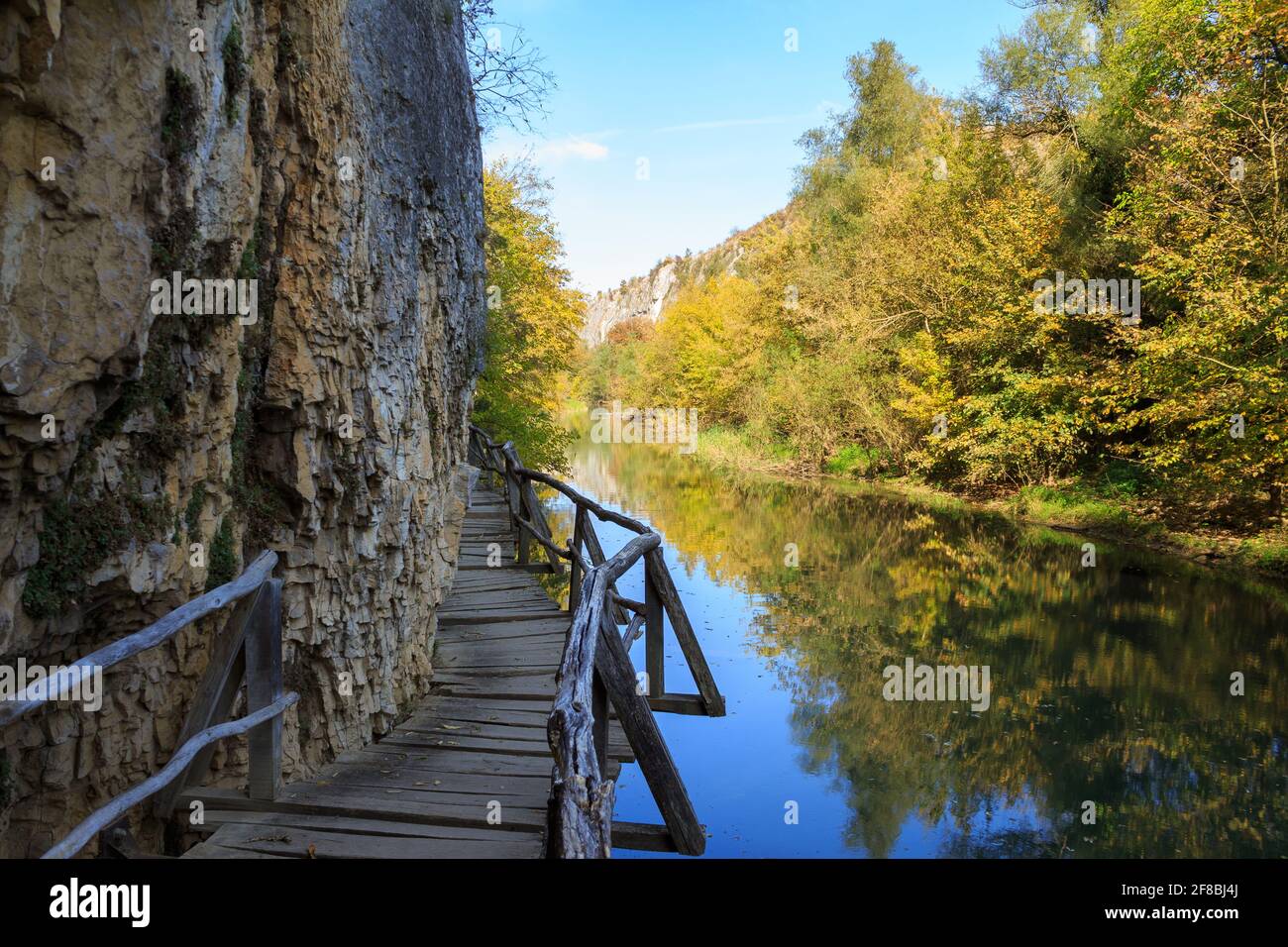 Tourist attraction - wooden bridge hanging on rocks over the river ...