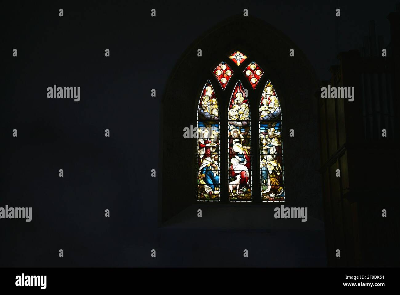 Stained glass window with religious icons on the interior of the ...