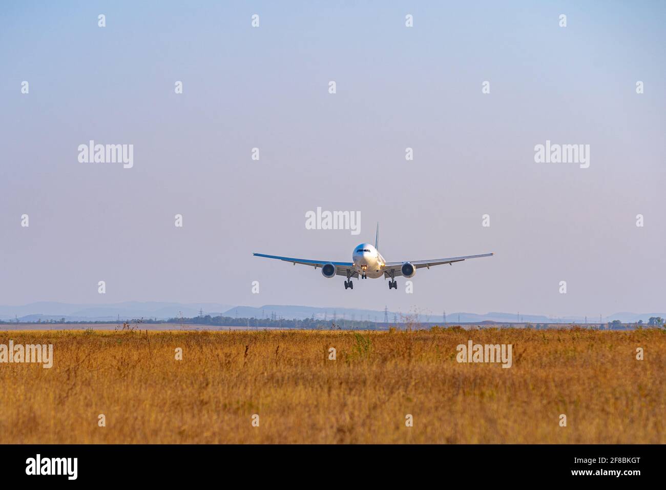Passenger plane takes off from runway in airport Stock Photo - Alamy