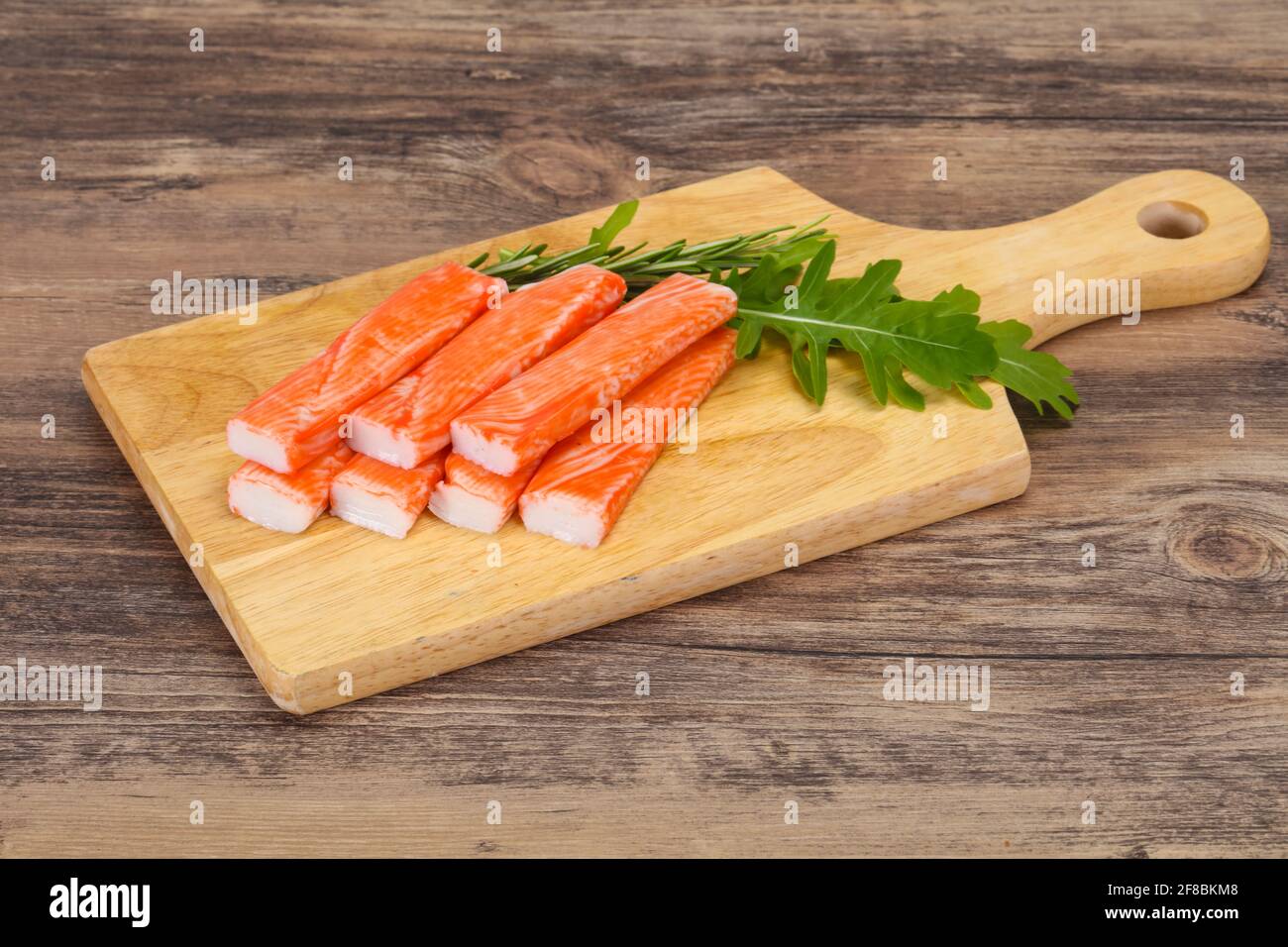Crab stick surimi over wooden board Stock Photo - Alamy