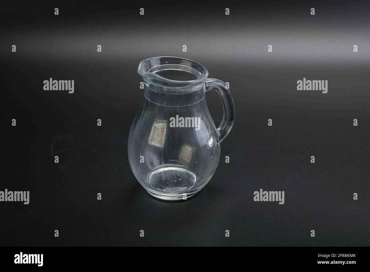 Empty glass jug for liquid isolated Stock Photo - Alamy