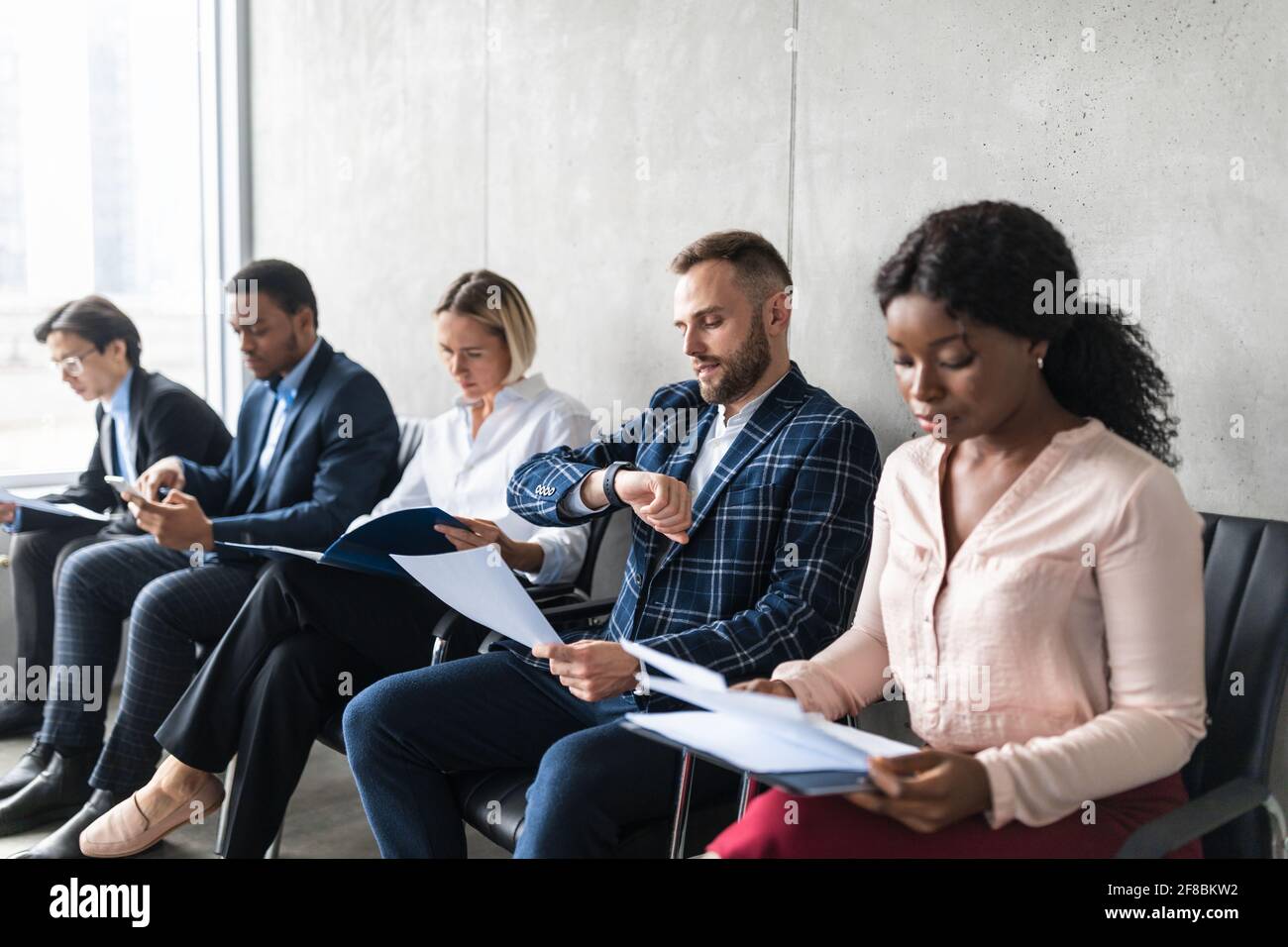 Multiracial Business People Waiting For Job Interview Sitting Indoors ...