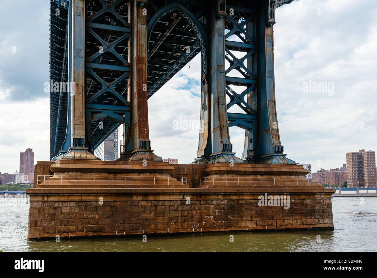 Detail of Pillar of Manhattan Bridge against cityscape of New York City ...