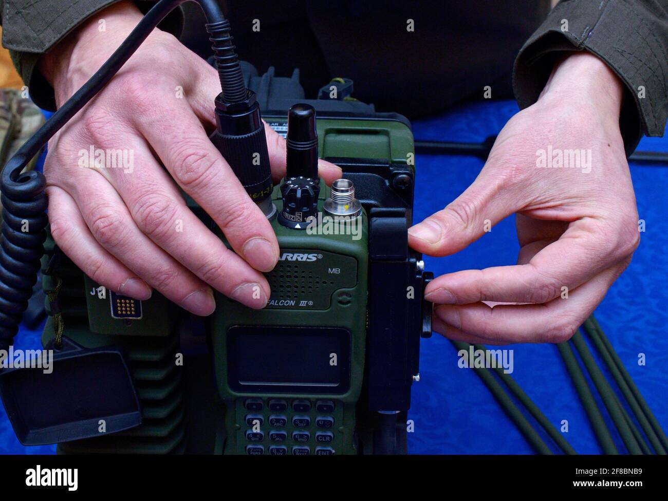 Soldier hands turning a personal police radio on Stock Photo - Alamy
