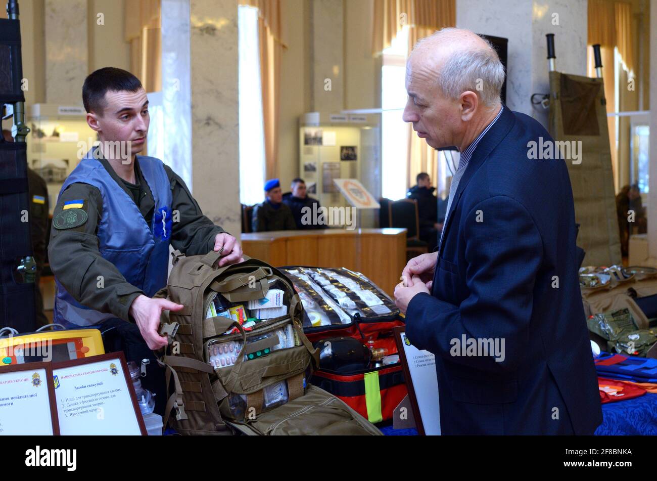 Man in military medic uniform showing to a visitor content of an ...