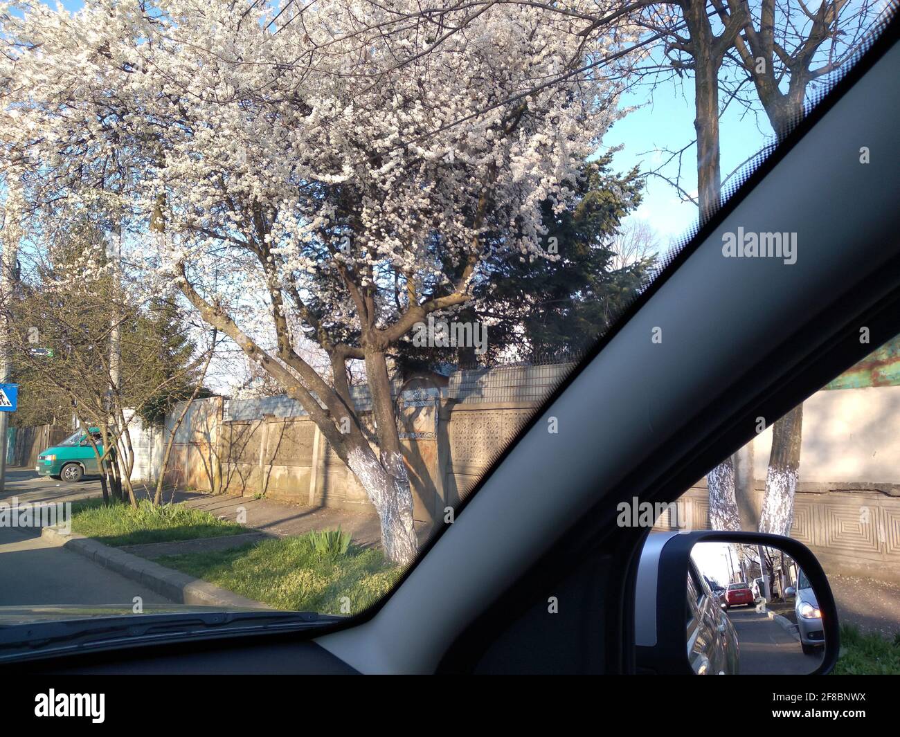 Road view through car window and mirror, cars on road in traffic in ...