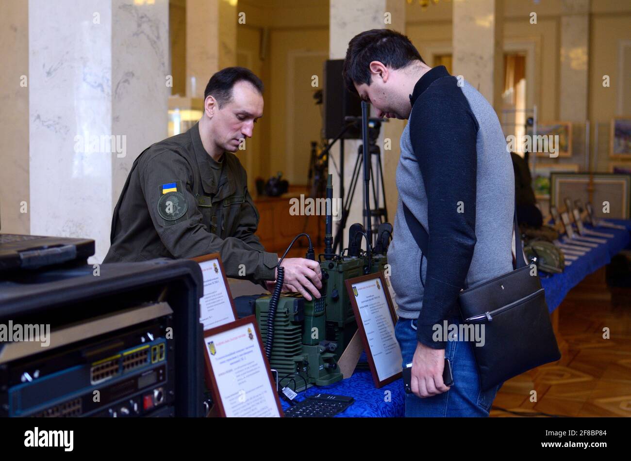 Ukrainian serviceman showing to visitor a personal police radio ...
