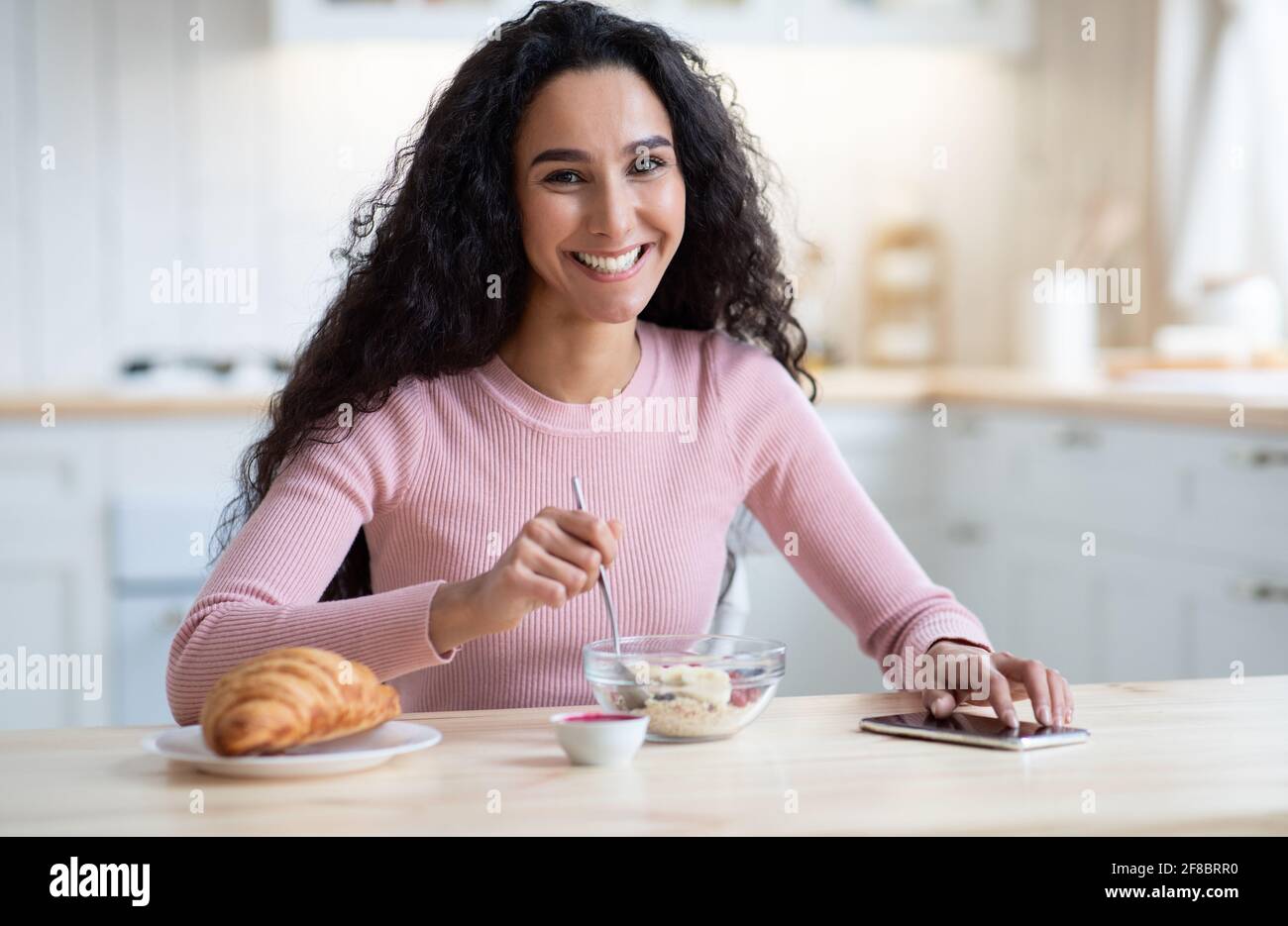 Domestic Morning. Happy Woman Eating Healthy Breakfast And Using ...