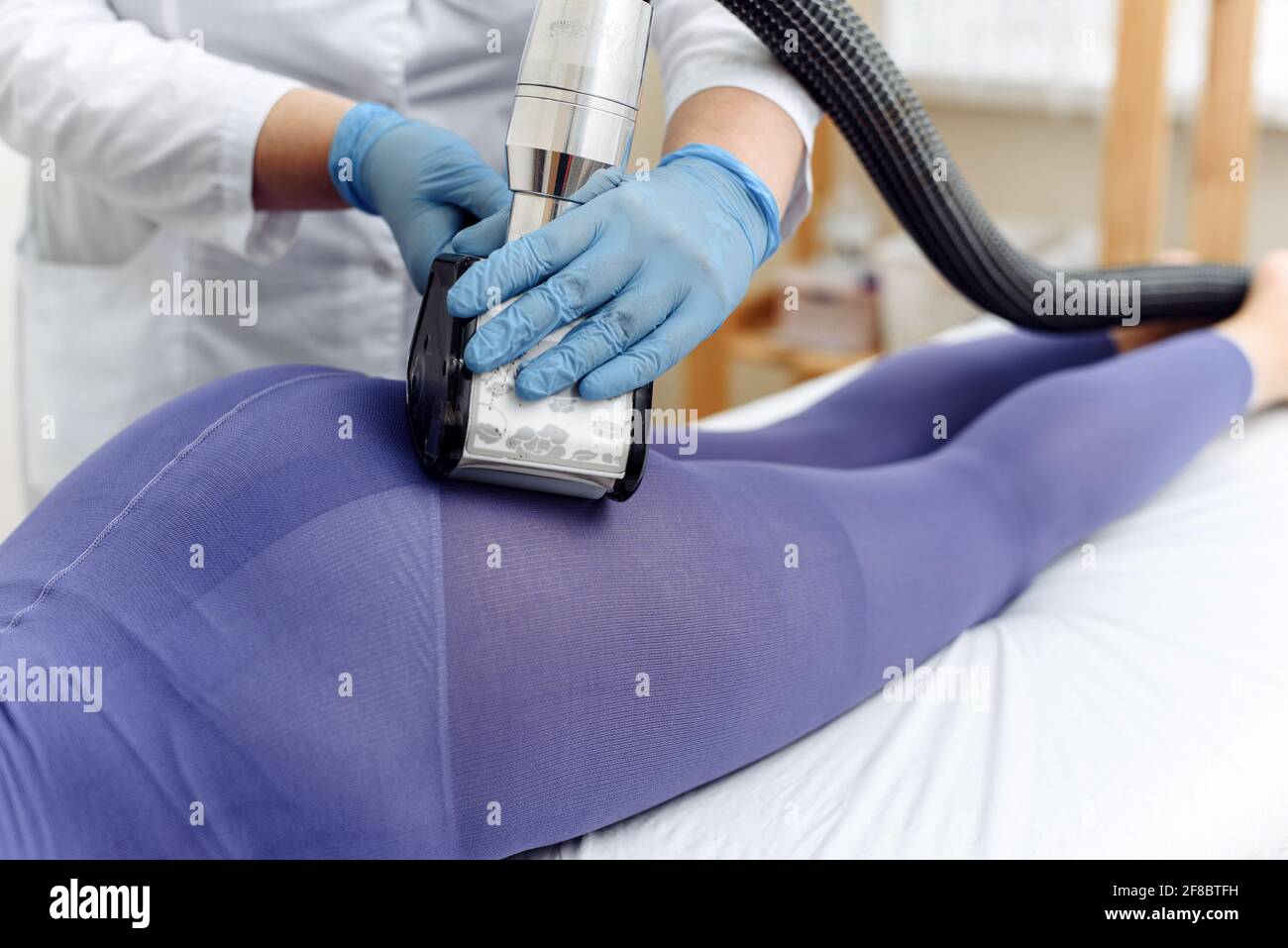 LPG, and body contouring treatment in clinic. Beautiful woman getting ...