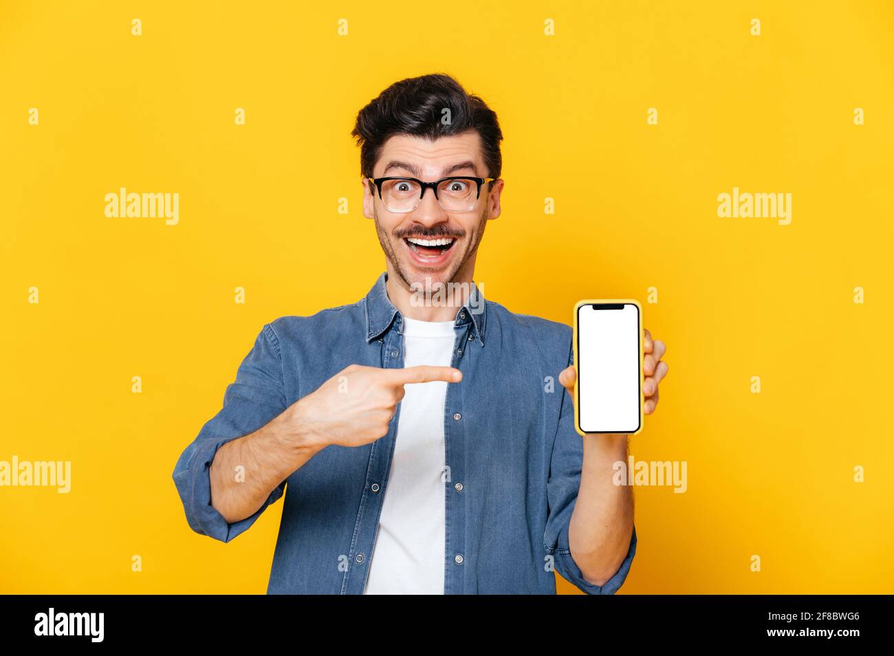 Happy charismatic unshaven caucasian guy in denim shirt and glasses ...