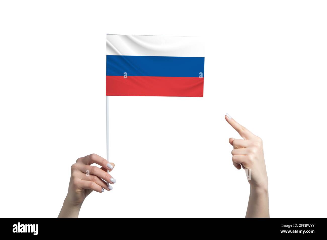 A beautiful female hand holds a Russia flag to which she shows the ...
