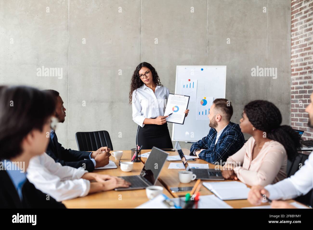 Female Marketing Specialist Making Business Presentation For Coworkers ...