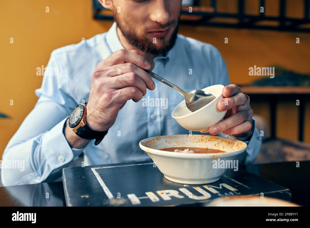 Man eating borscht and pilaf cafe restaurant interior business finance ...