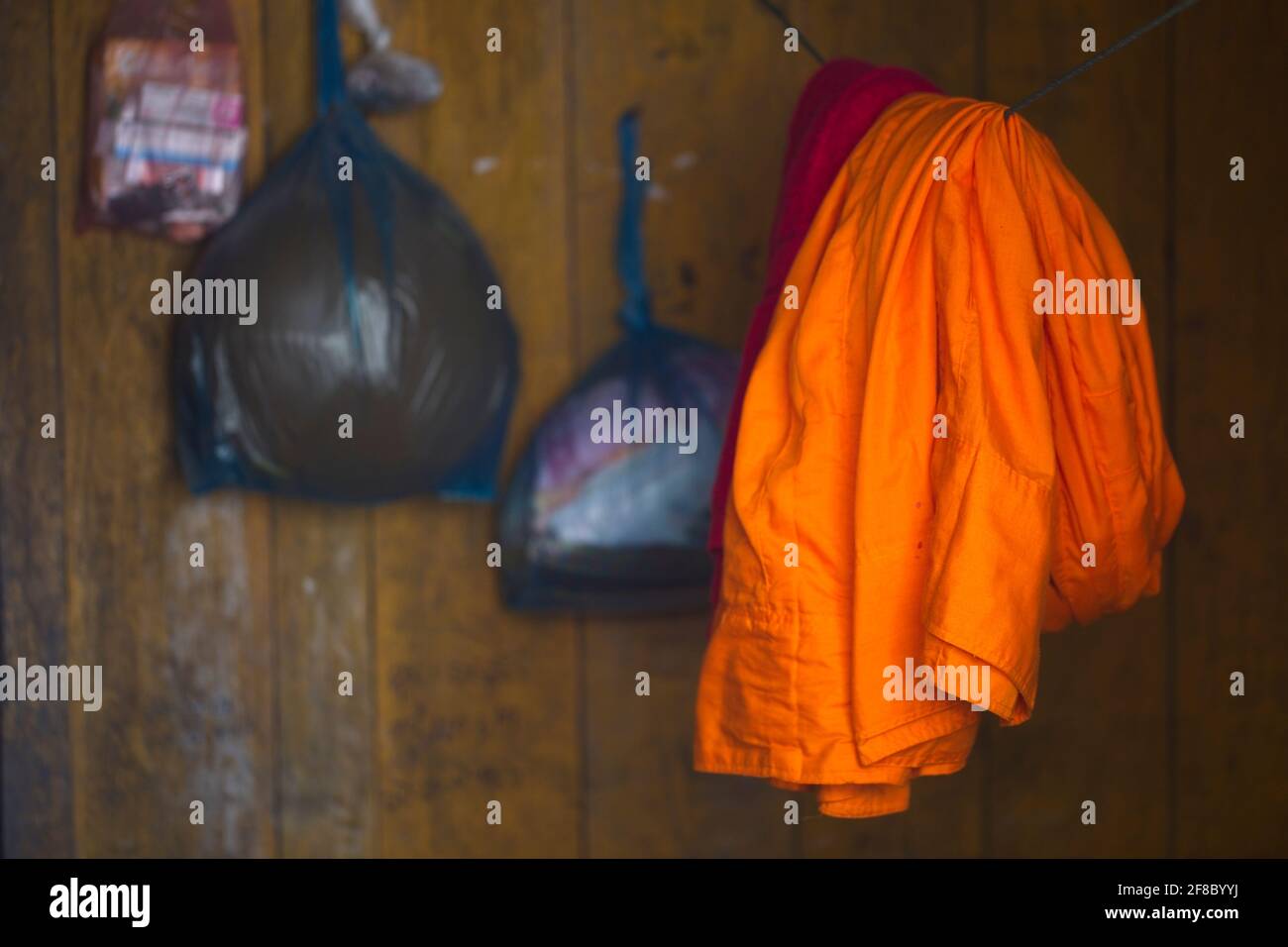 Orange monk dressing in monastery Phongsali Laos Stock Photo - Alamy