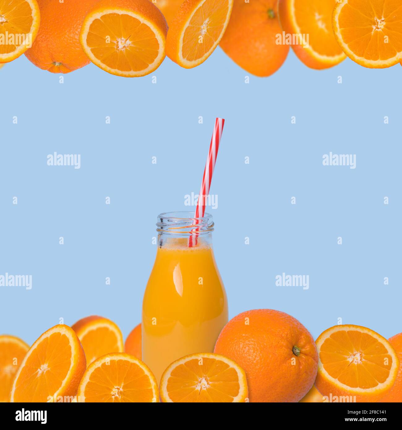 Minimal creative idea, frame made of fresh slices of orange and bottle ...