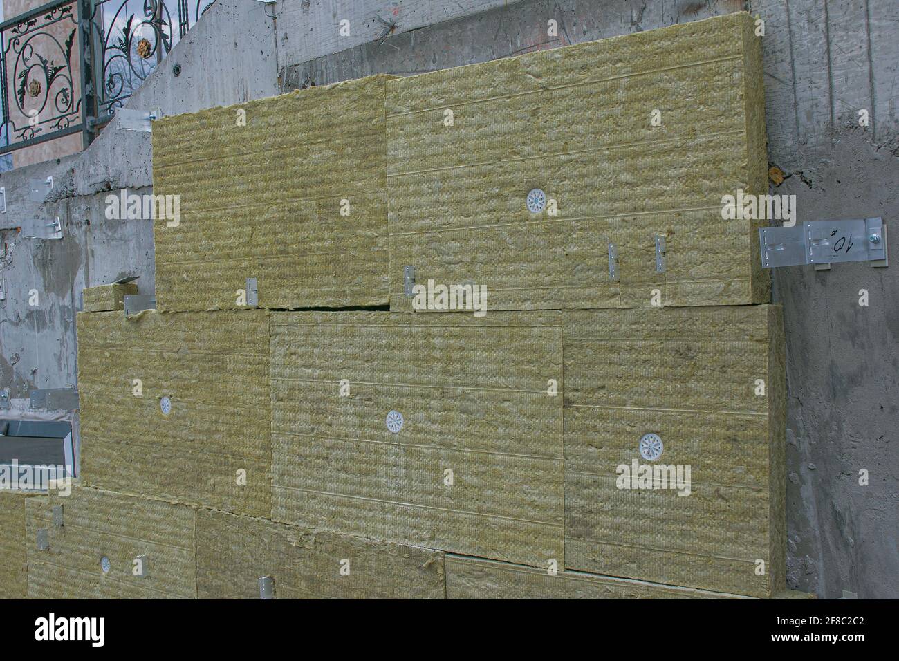 The installed layer of thermal insulation on the staircase wall from ...